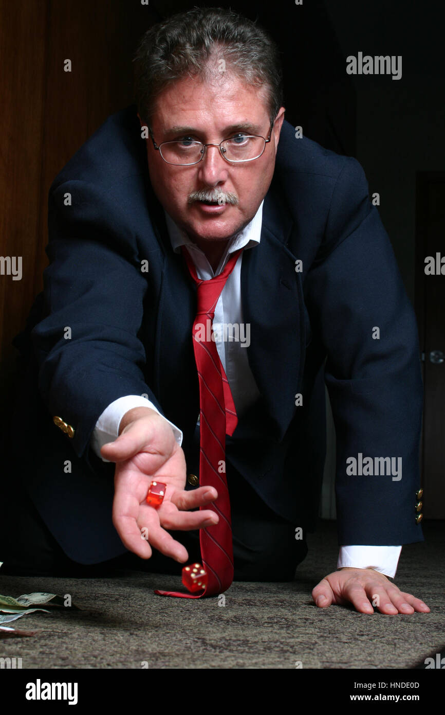 A businessman rolls the dice Stock Photo - Alamy
