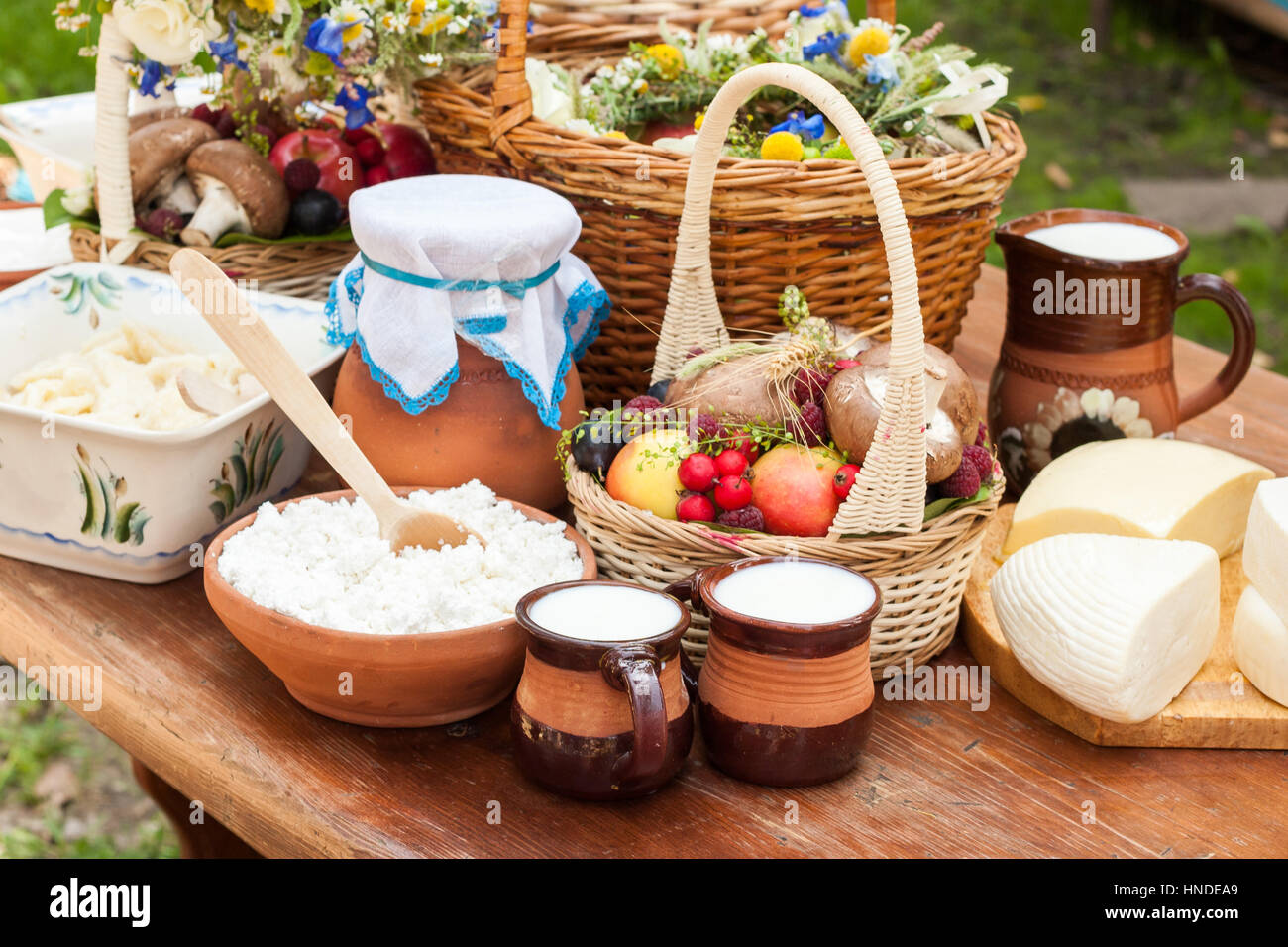 Dairy products on wooden table. Cheese and milk on the table in an ...