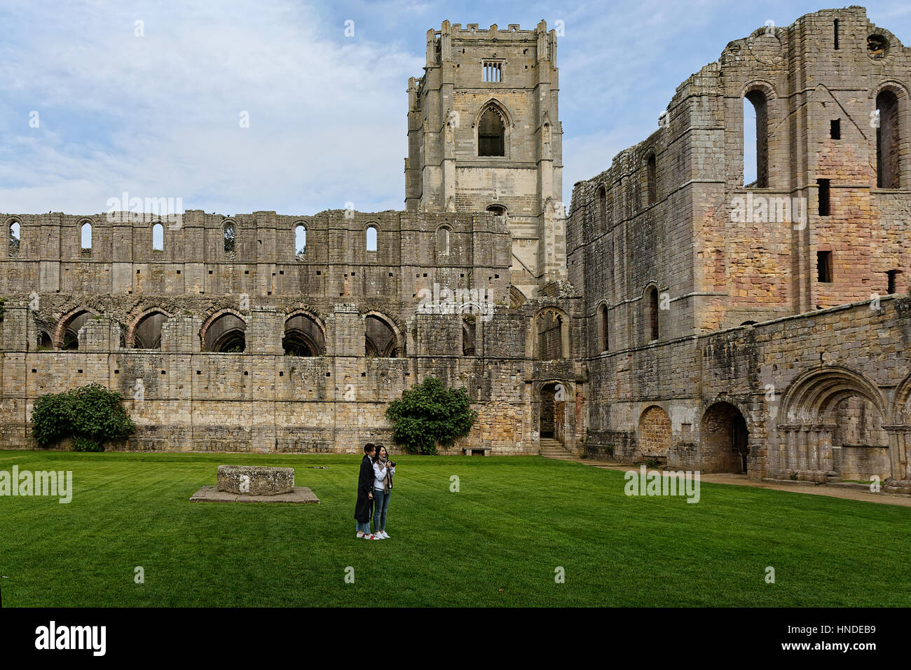 Tourists in the Cloister Court of the World Heritage Site ruins of ...