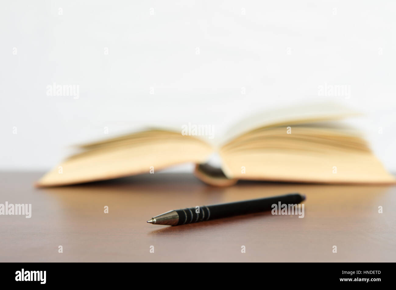 pen on background of a stack of colorful books isolated Stock Photo - Alamy