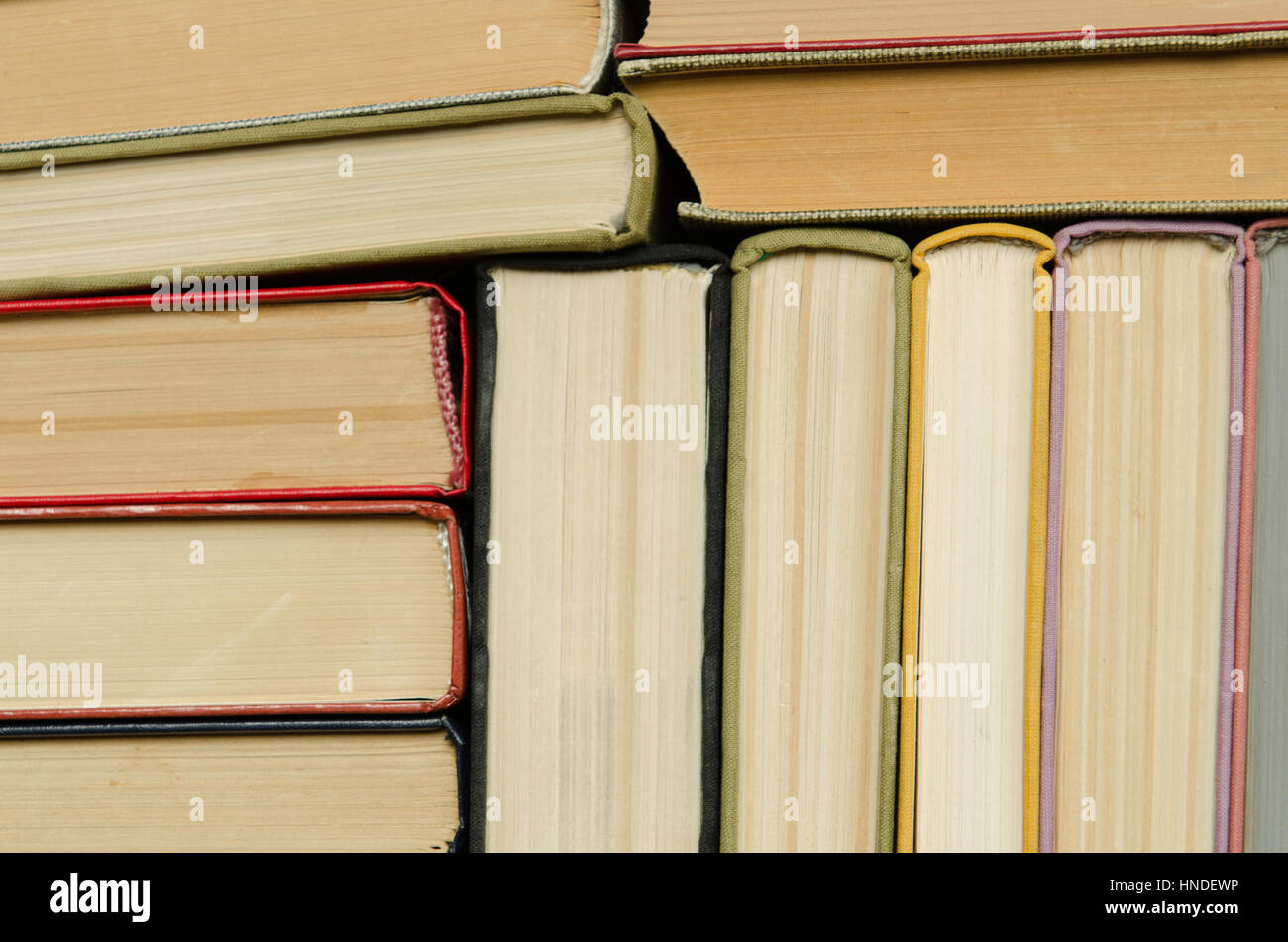 a stack of colorful books in a library or a room Stock Photo - Alamy