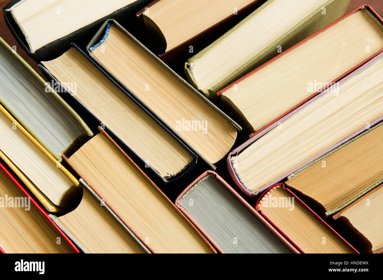 a stack of colorful books in a library or a room Stock Photo - Alamy