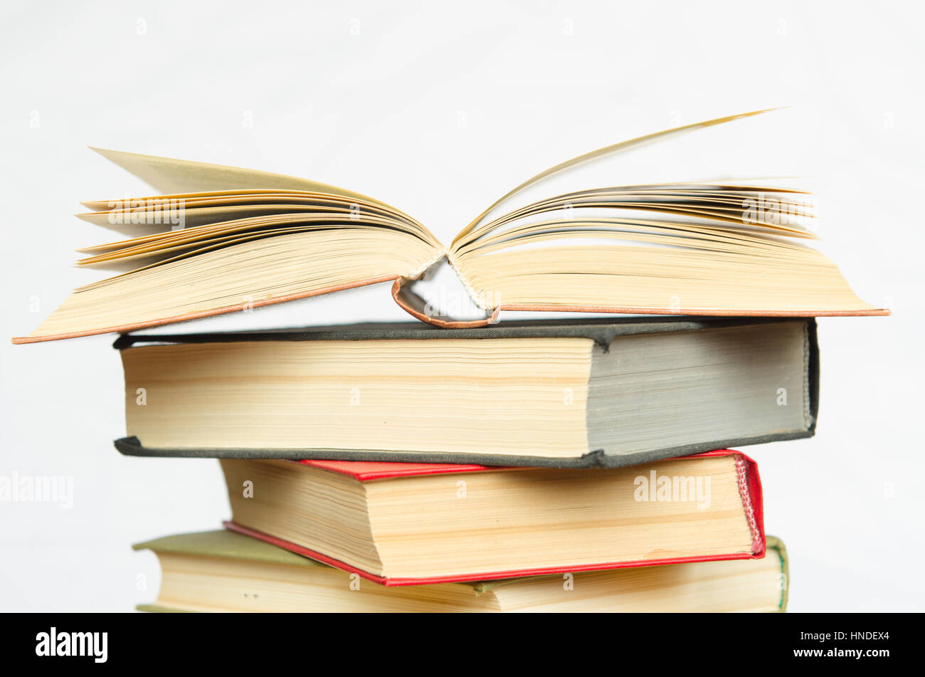 a stack of colorful books in a library or a room isolated on white ...