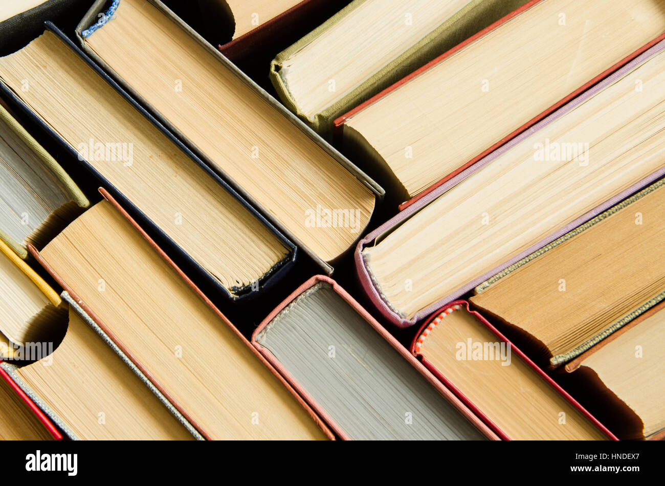 a stack of colorful books in a library or a room Stock Photo - Alamy