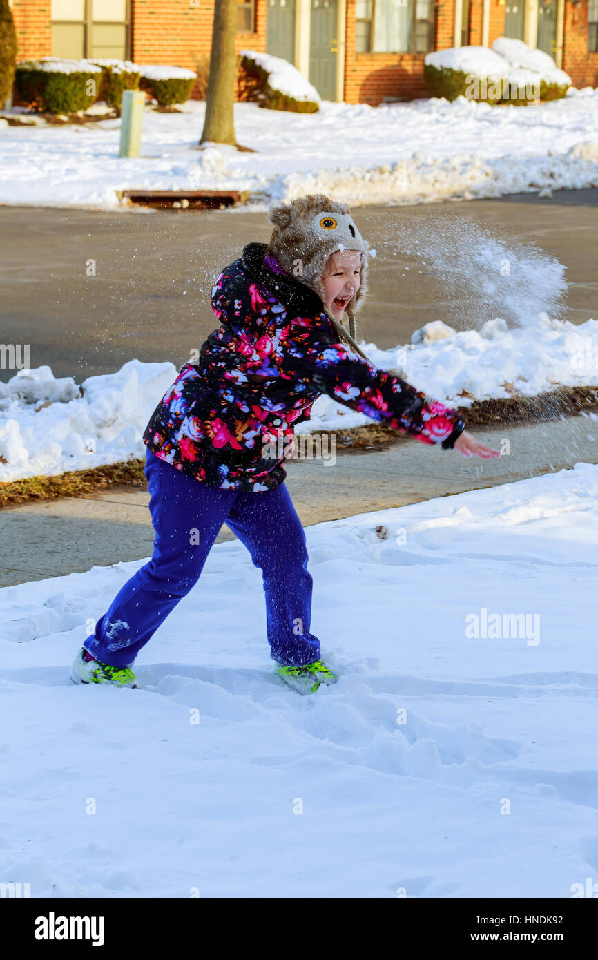 Winter snow little girl playing with snow Stock Photo - Alamy