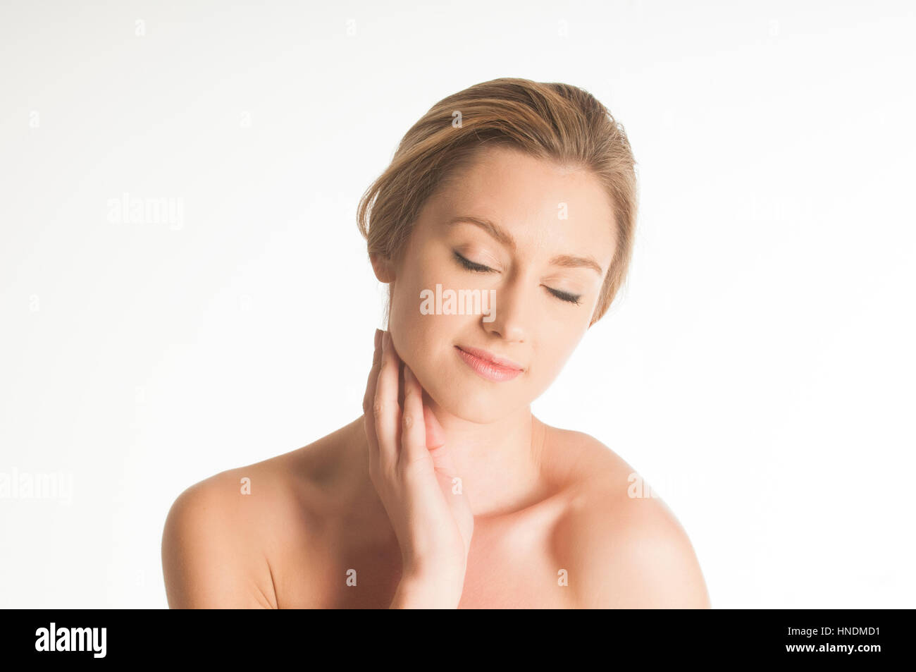 Beautiful blonde woman hand touching skin against a white background ...