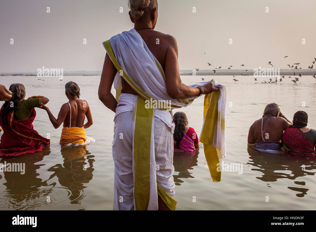 Pilgrims praying and bathing, in the ghats of Ganges river, Varanasi ...