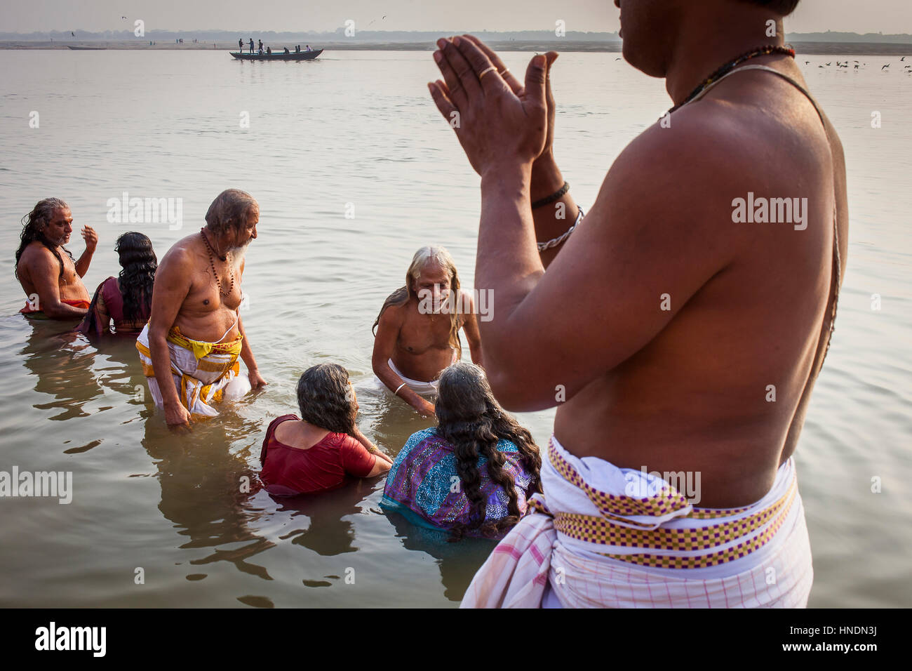Pilgrims praying and bathing, in the ghats of Ganges river, Varanasi ...