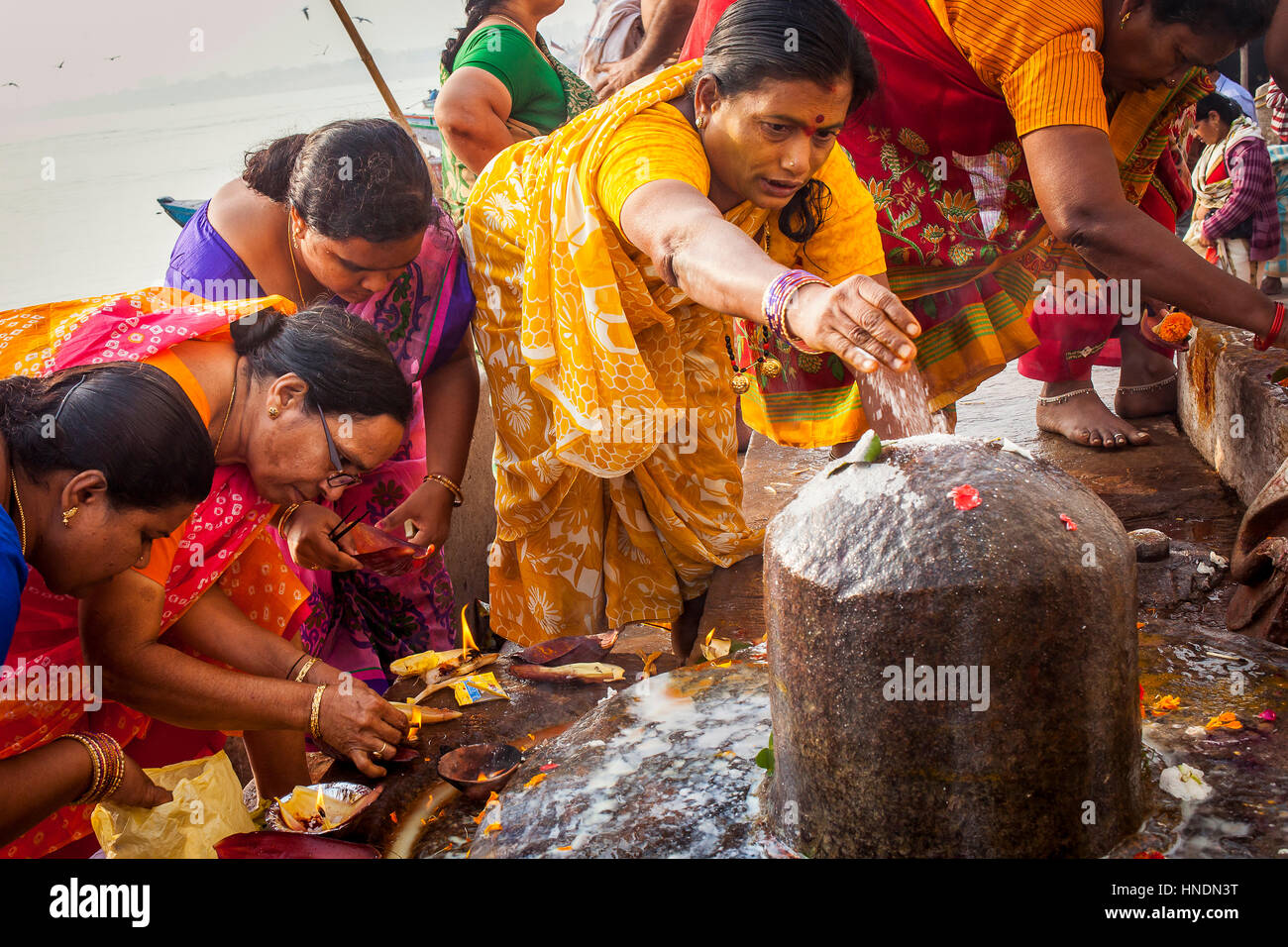 Women, Pilgrims making a ritual offering, and praying, ghats in Ganges ...