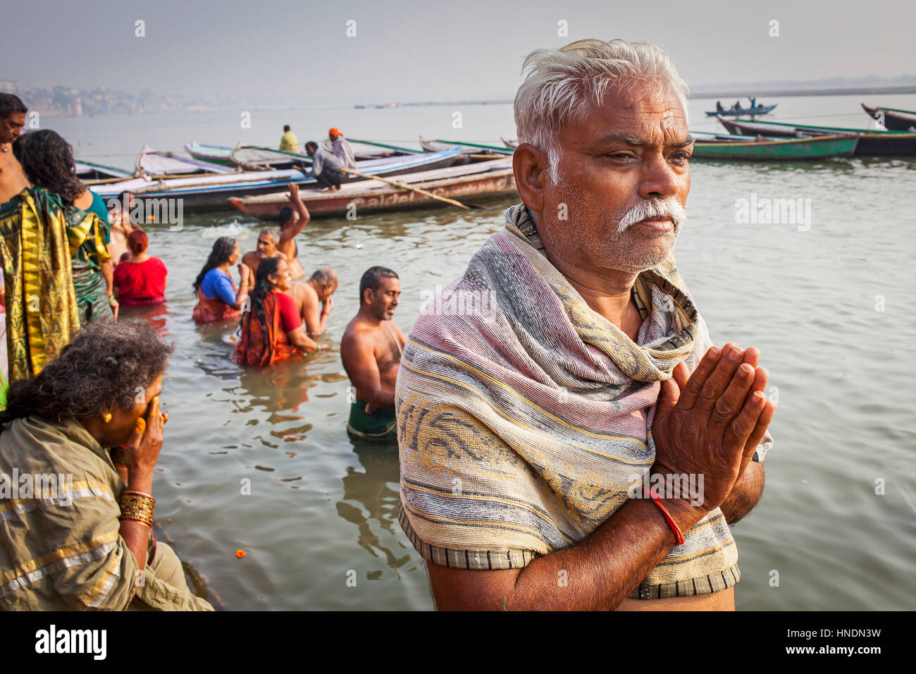Pilgrims praying and bathing, in the ghats of Ganges river, Varanasi ...