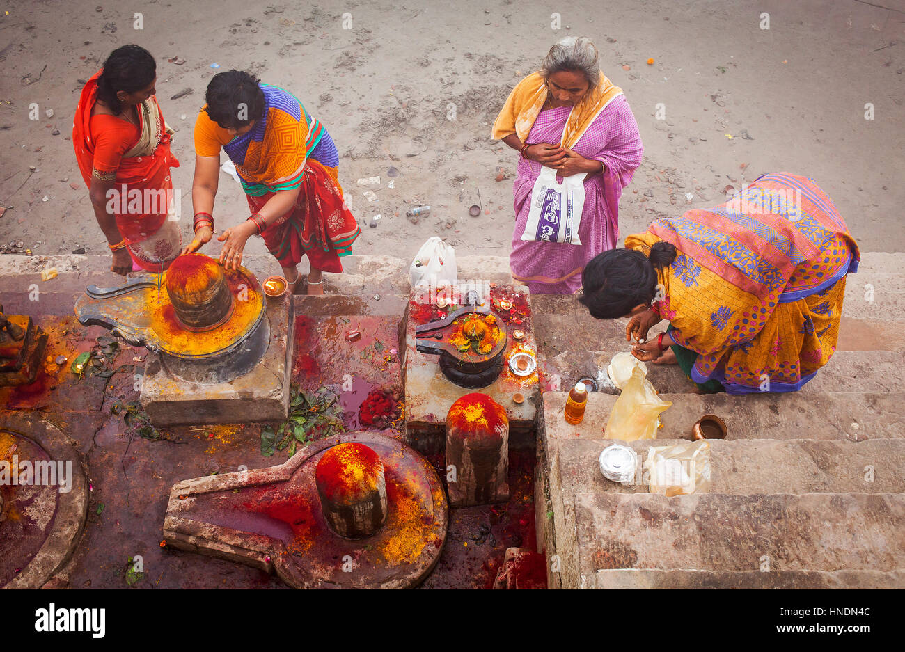 women, Pilgrims making a ritual offering and praying, ghats of Ganges ...