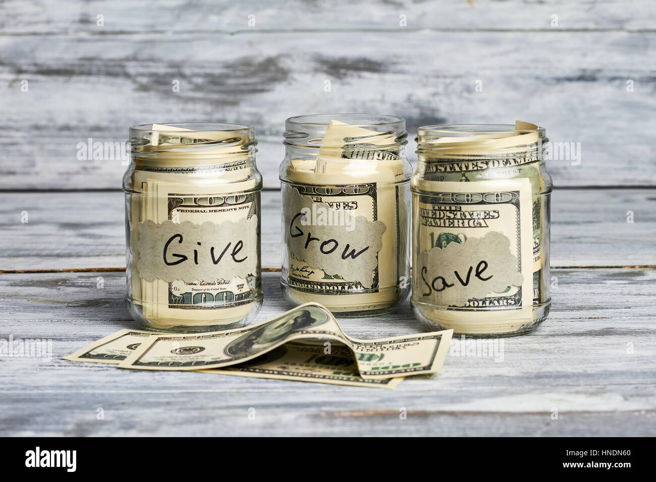 Glass jars with money Stock Photo - Alamy
