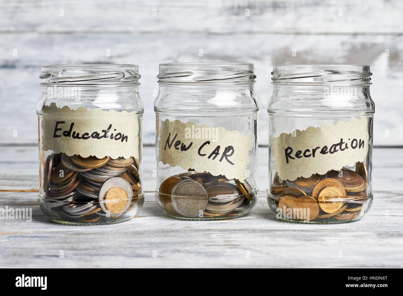 Three jars with coins Stock Photo - Alamy