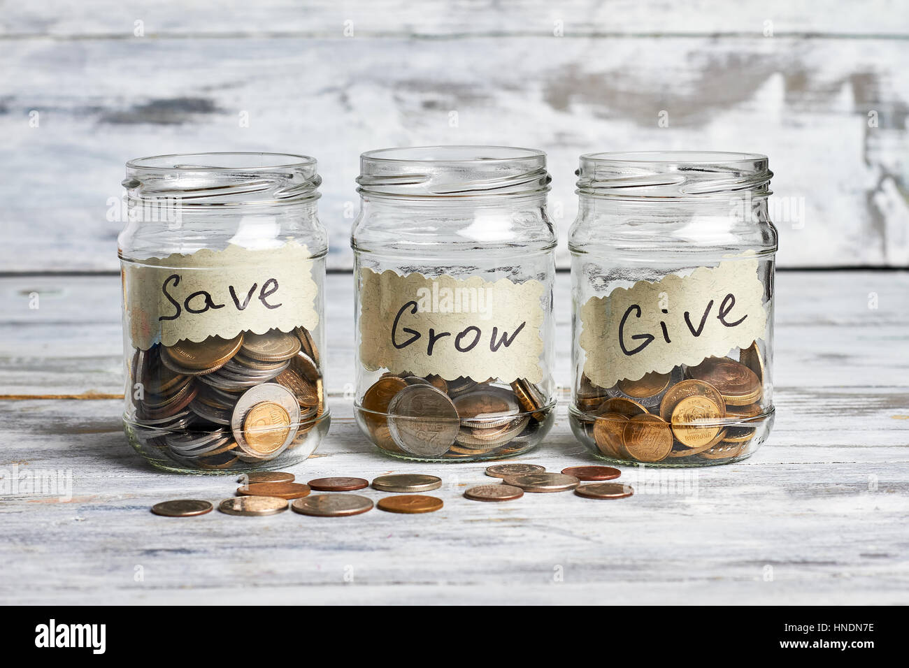 Glass containers with coins Stock Photo - Alamy