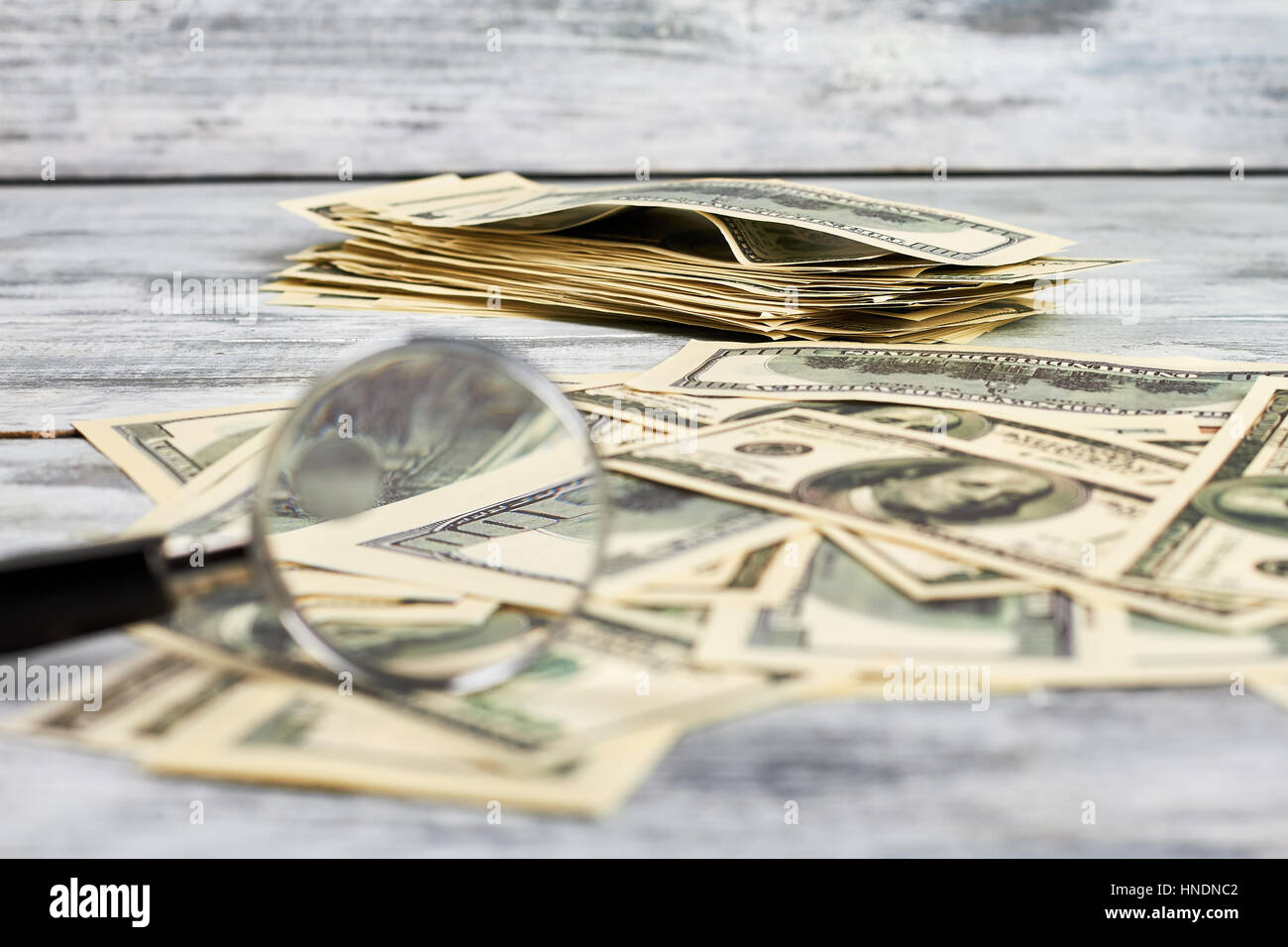 Magnifying glass and dollars Stock Photo - Alamy