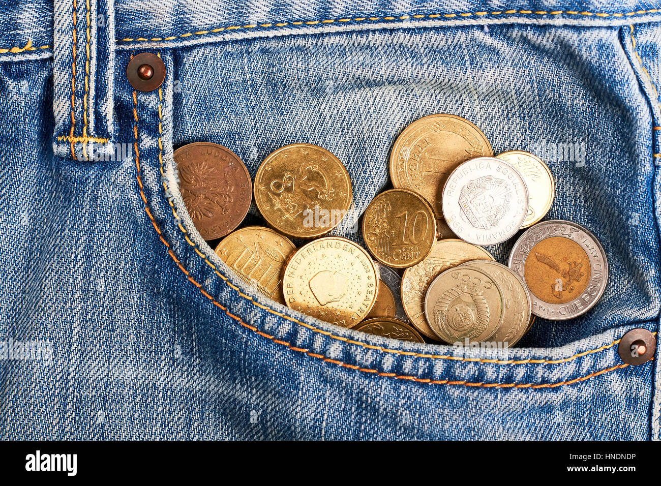 Coins in faded jeans Stock Photo - Alamy