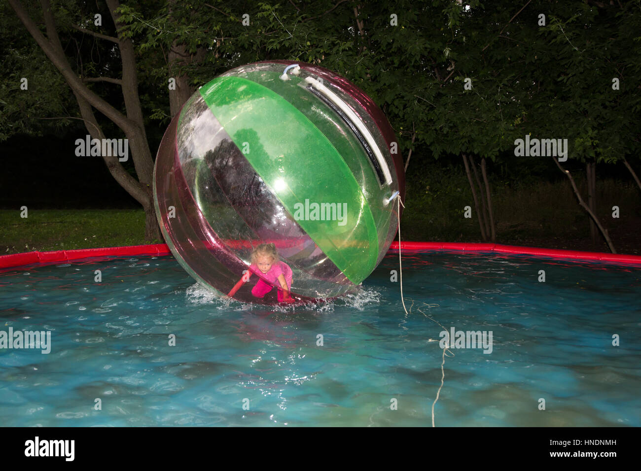 little girl in a Zorb in the pool Stock Photo - Alamy