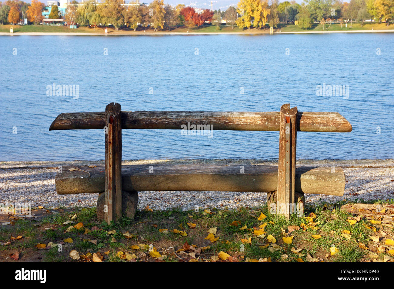 Wooden bench with a view on the lake Stock Photo - Alamy
