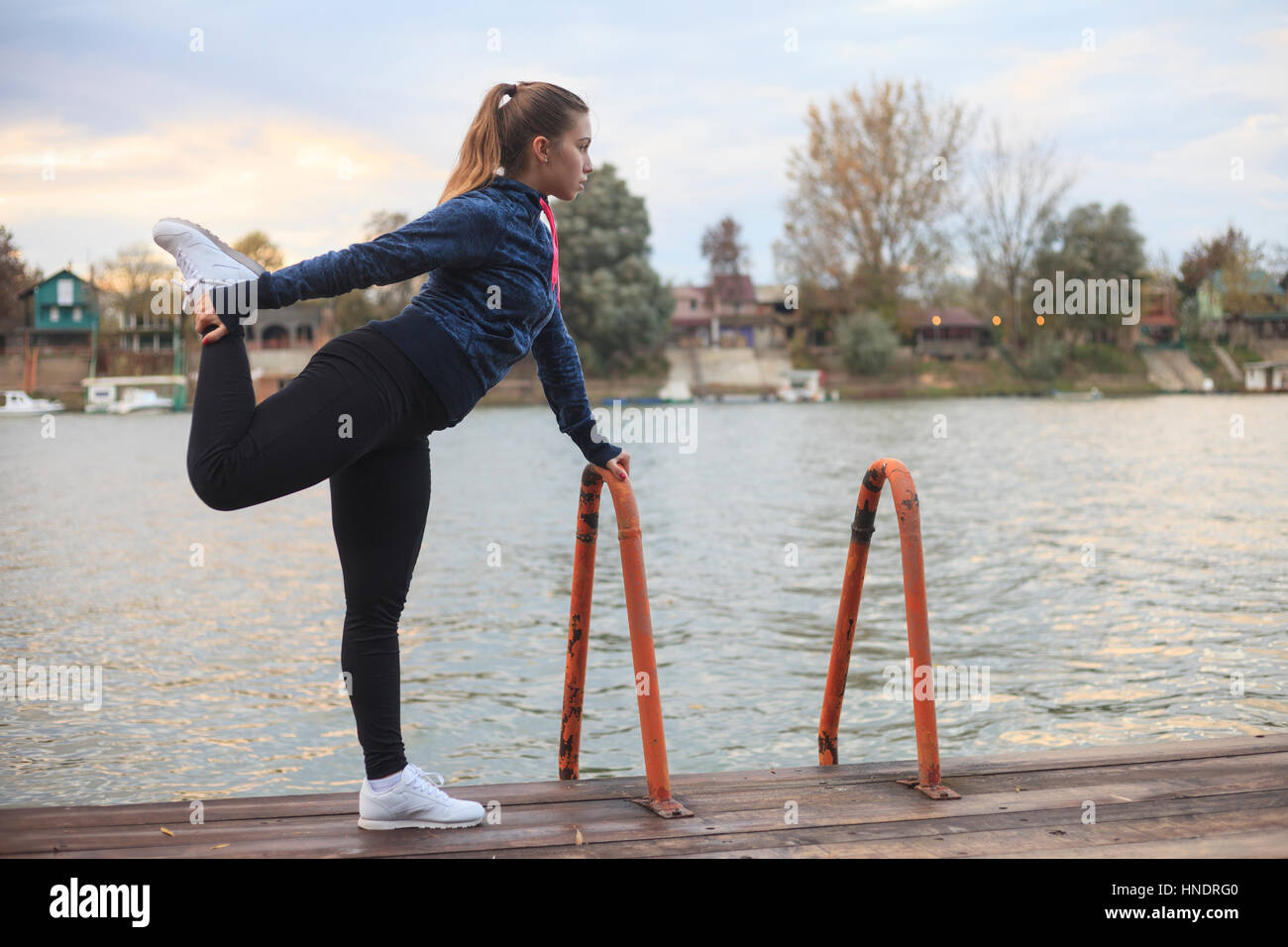 A young woman exercises by the river Stock Photo - Alamy