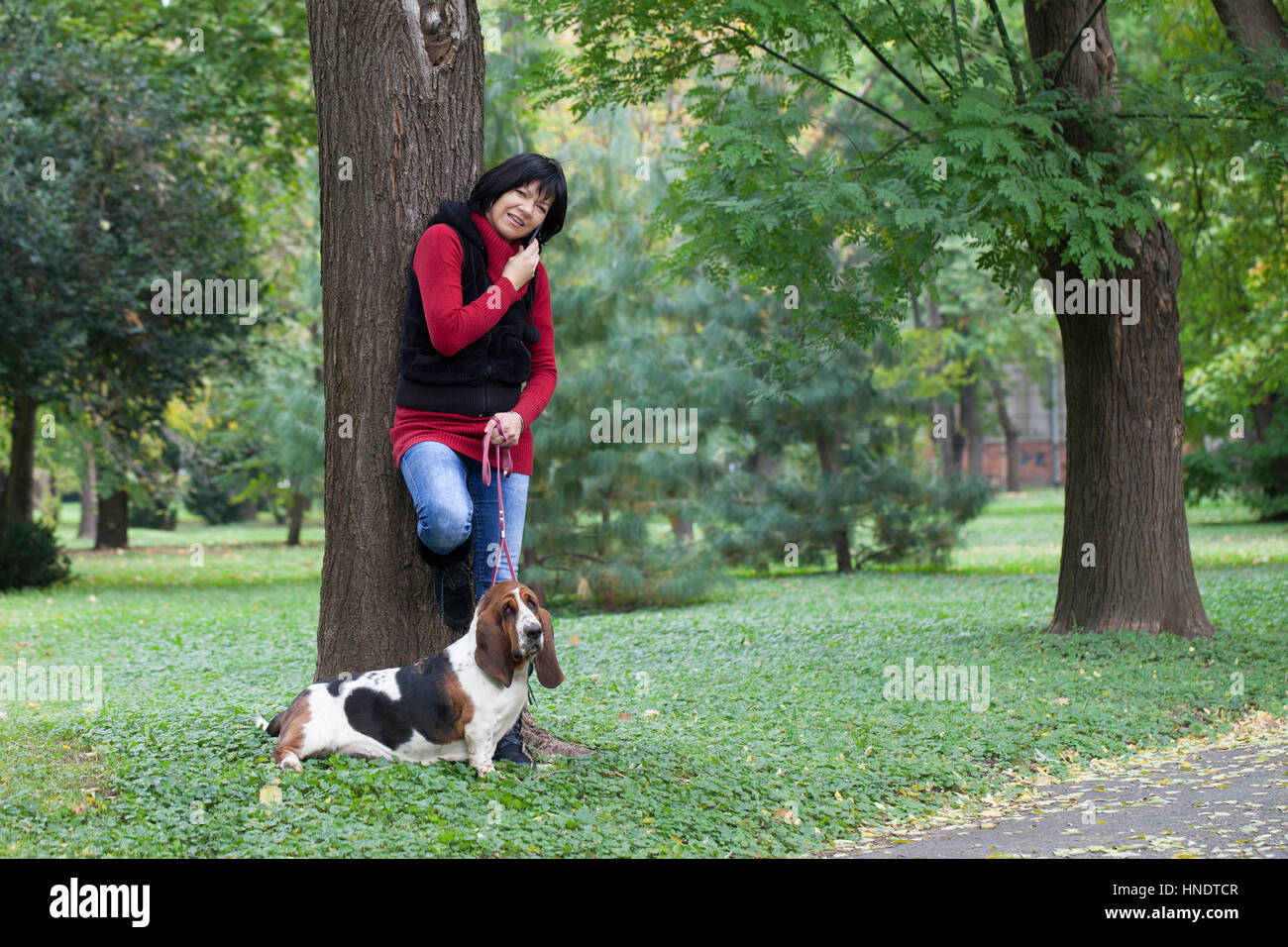 Young woman walking with her dog, Selective focus and small depth of ...