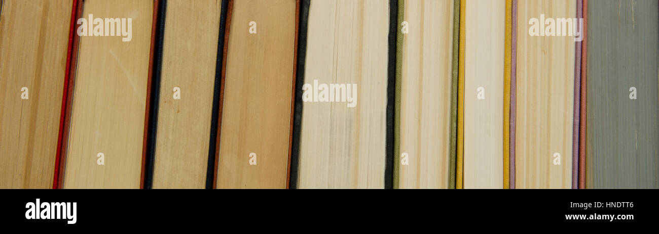 a stack of colorful books in a library or a room Stock Photo - Alamy