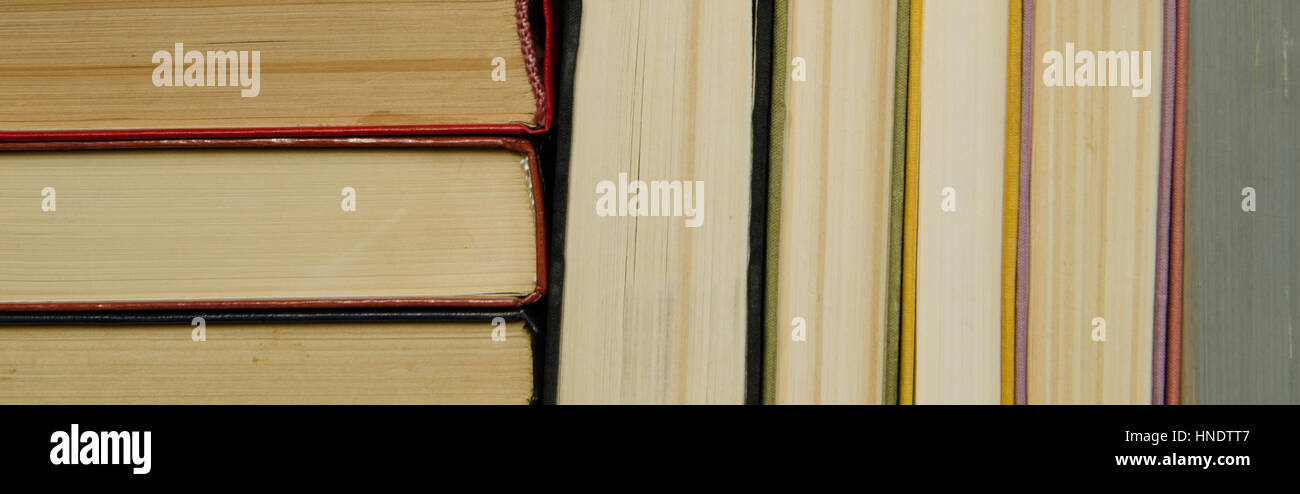a stack of colorful books in a library or a room Stock Photo - Alamy
