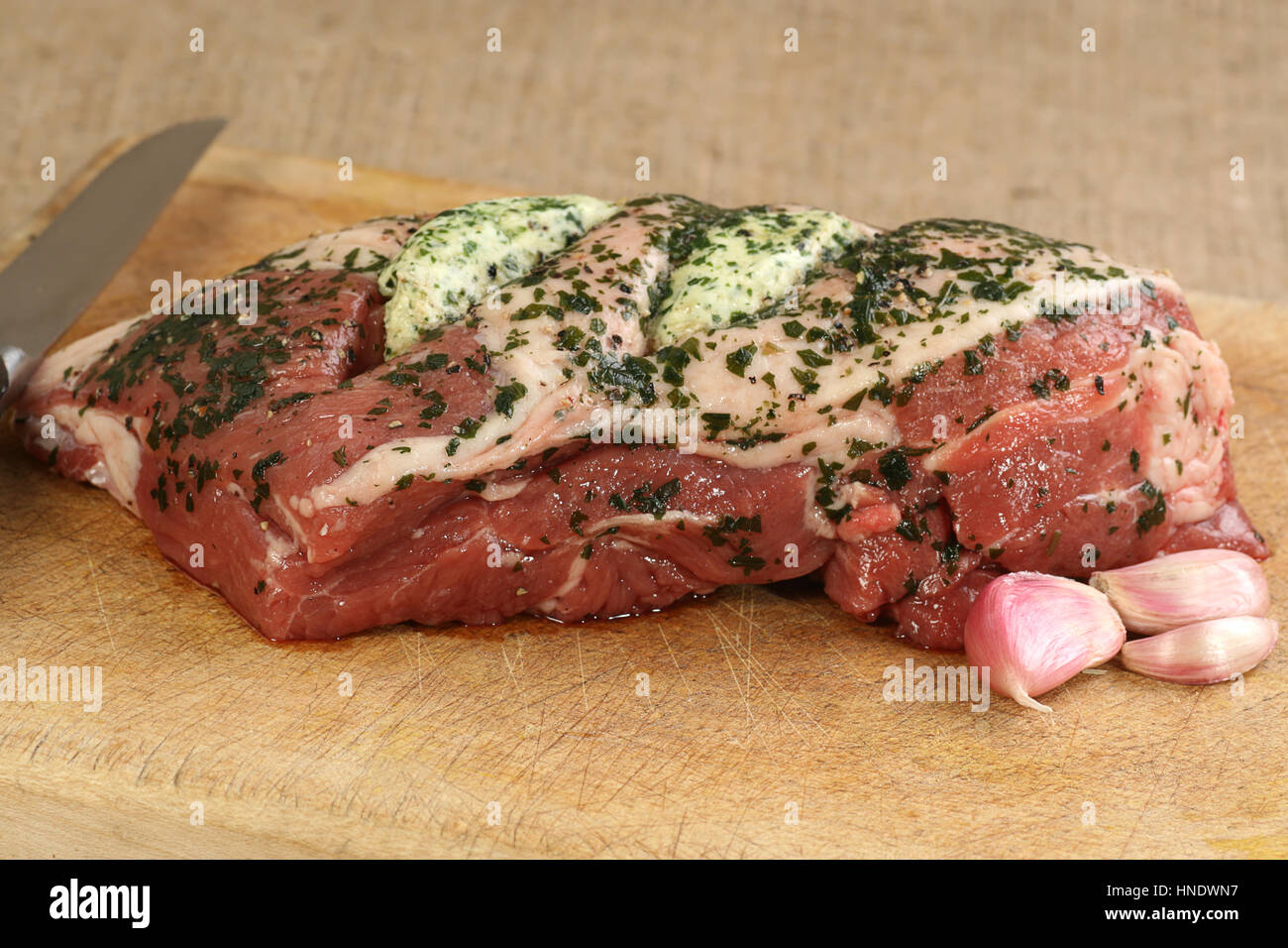 uncooked lamb shoulder with garlic and herb butter Stock Photo - Alamy
