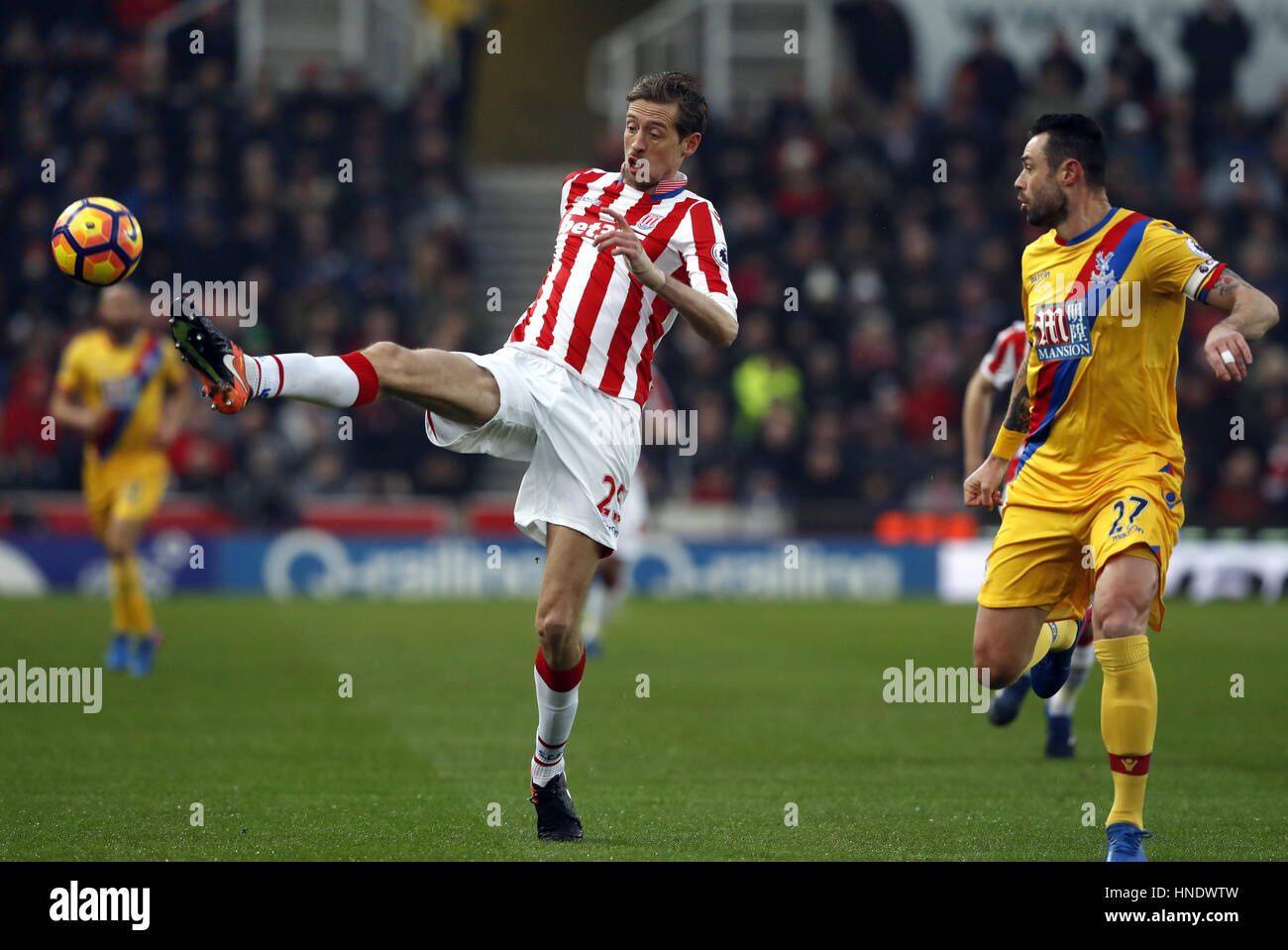 Stoke citys peter crouch controls ball under pressure hi-res stock ...