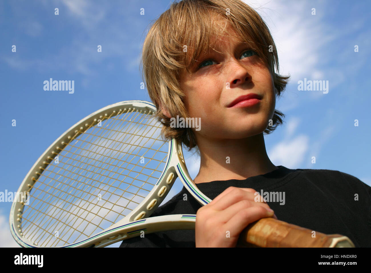 a teen boy holding a tennis racket Stock Photo - Alamy