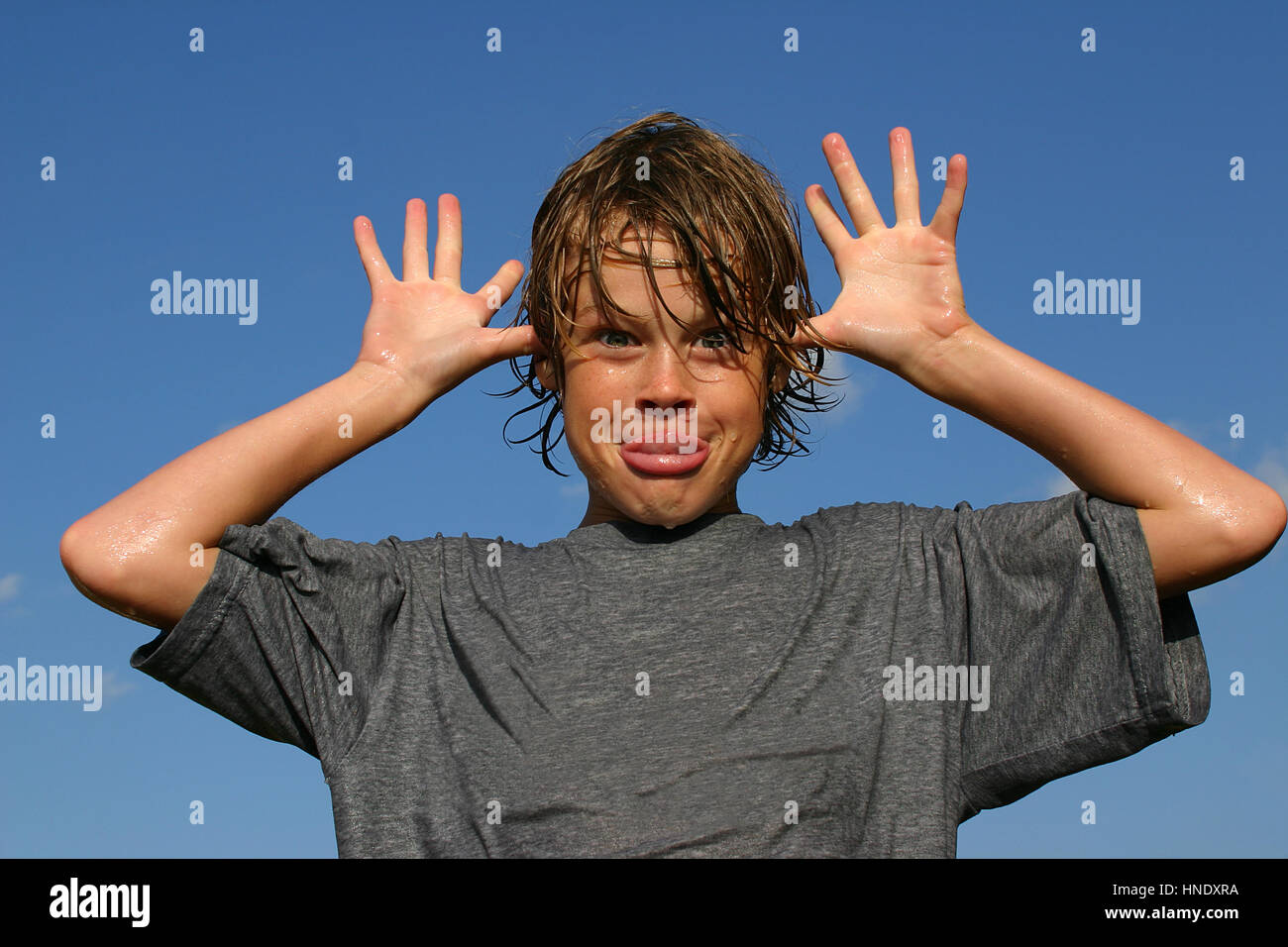 a teen boy making a silly face Stock Photo - Alamy