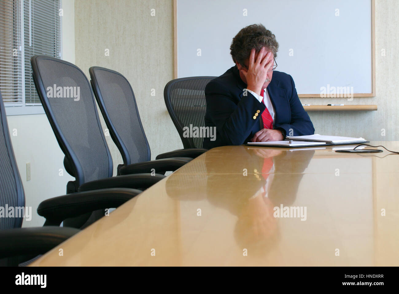 a depressed business man sits in a conference room Stock Photo - Alamy