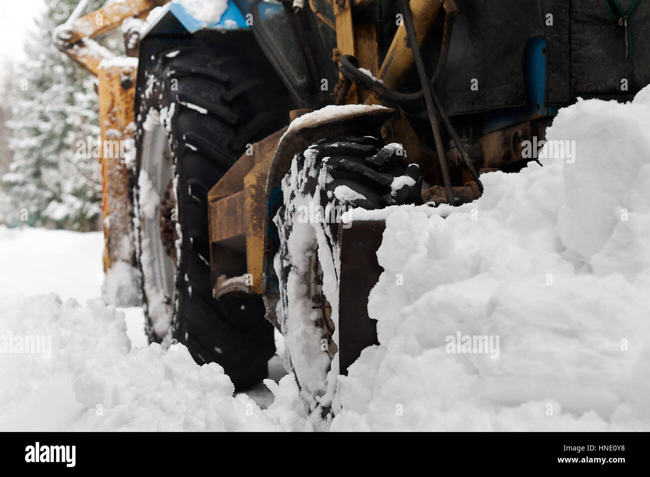 A tractor plowing heavy snow, focus in the foreground Stock Photo - Alamy