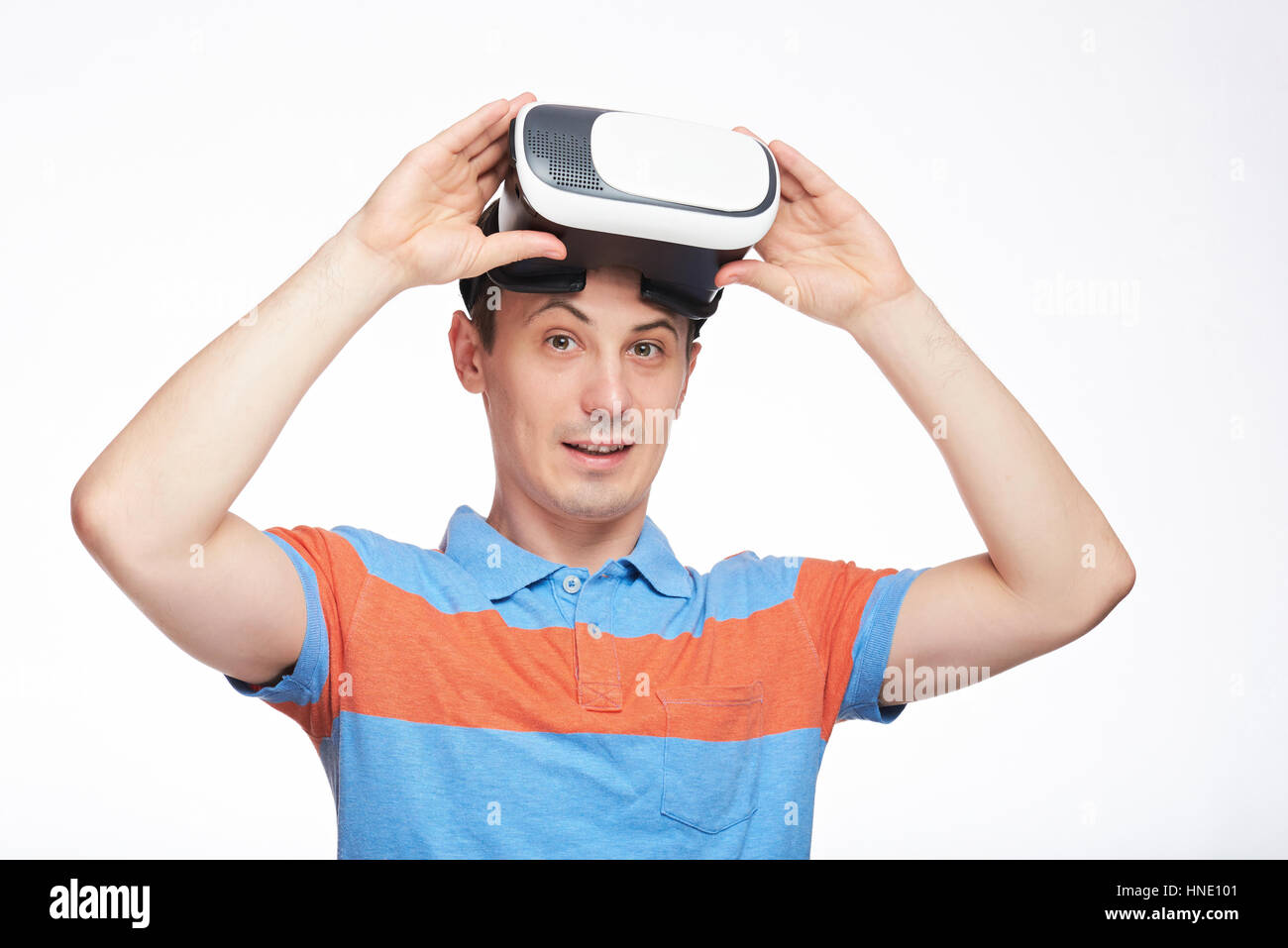 smiling man with VR glasses on head. Guy wearing virtual reality ...