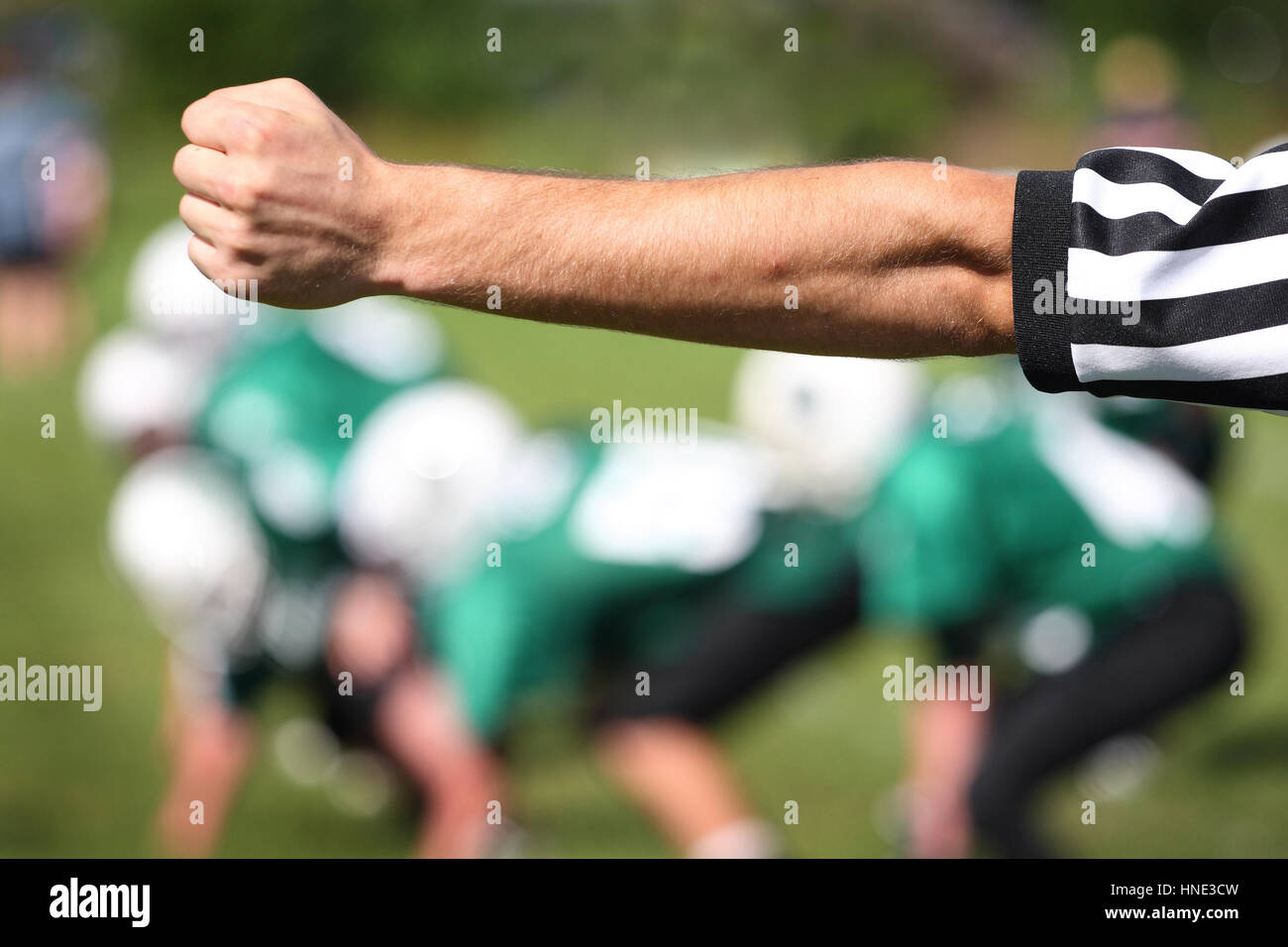 A referee's arm outstretched at the beginning of a play Stock Photo - Alamy