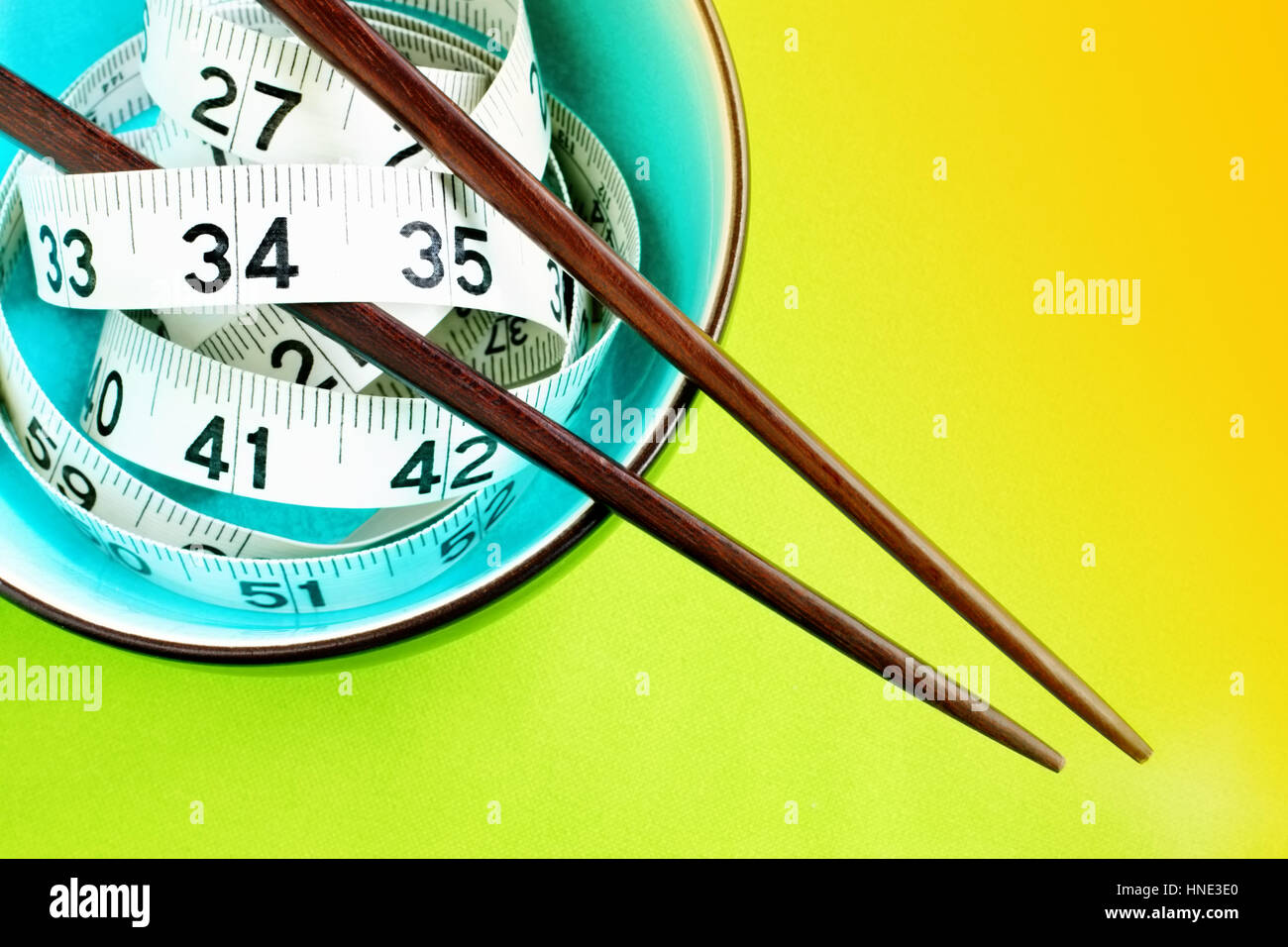 A plate with tape measure and chopsticks Stock Photo - Alamy