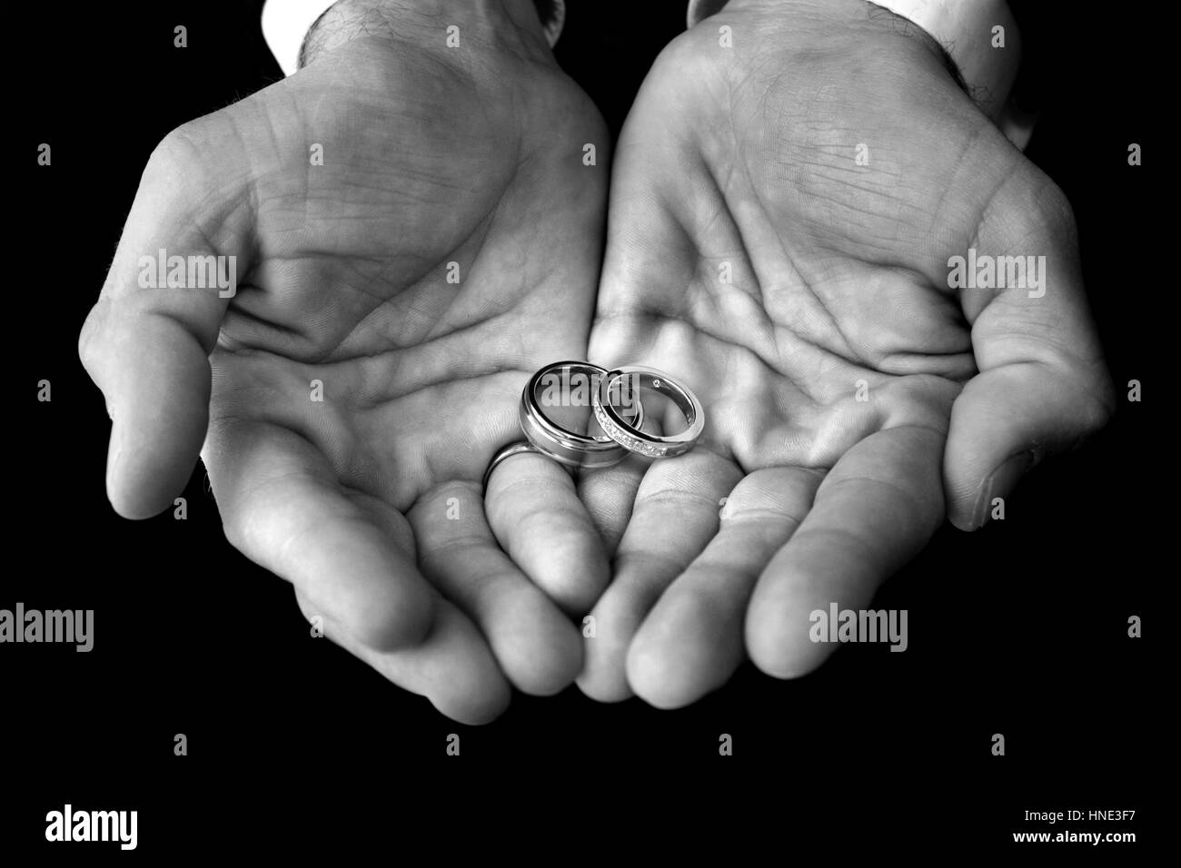 hands holding wedding rings Stock Photo - Alamy