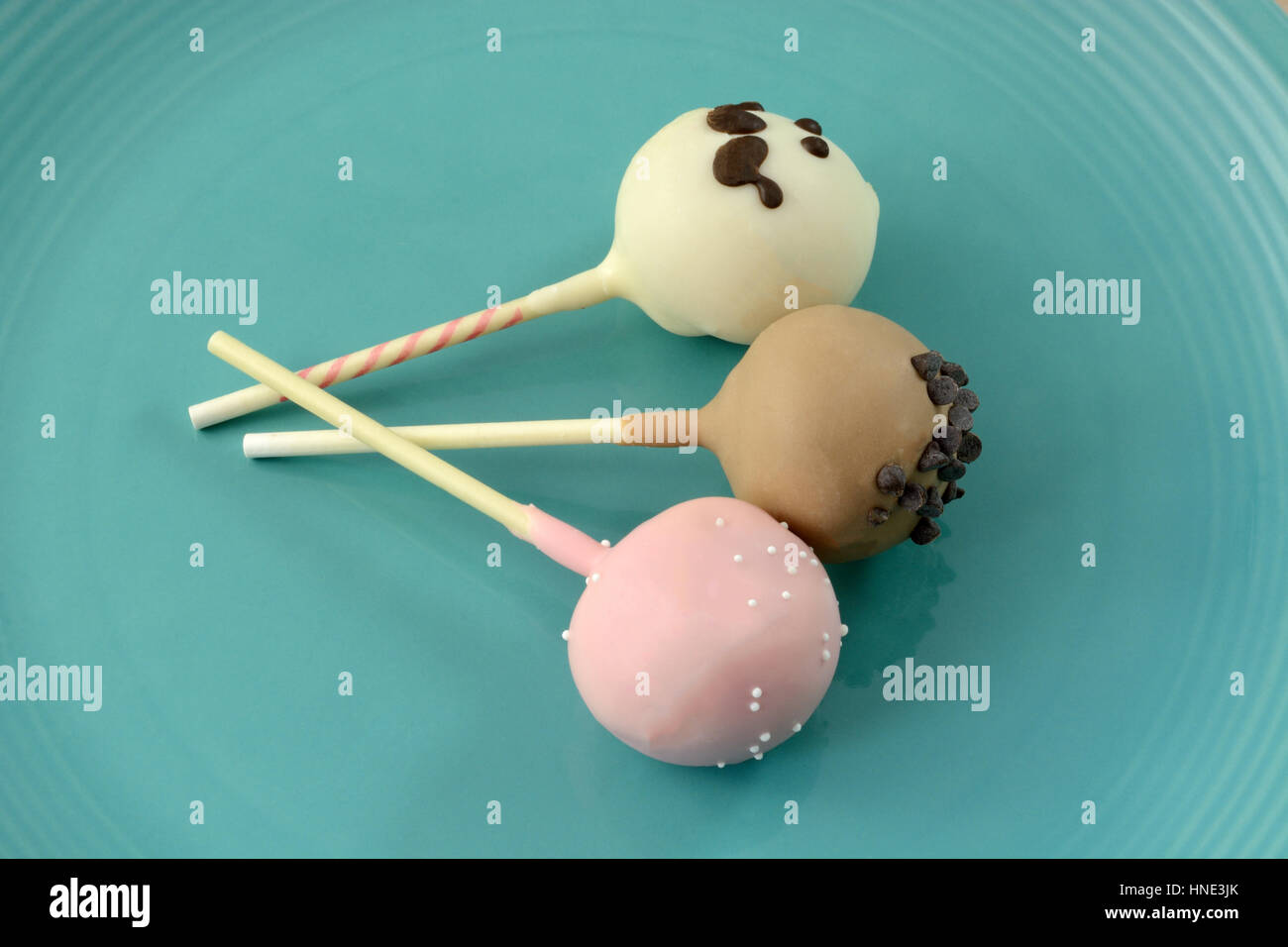 Three different cake pop popsicles on blue plate Stock Photo - Alamy