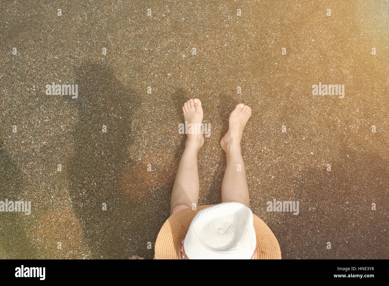barefoot legs in calm clean ocean water in sunny day view from top ...