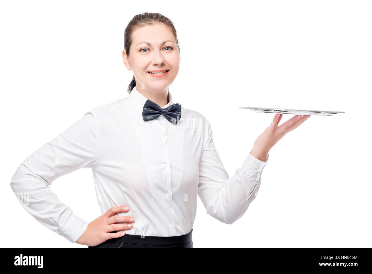 Elegant waiter with a tray on his hand posing on a white background ...