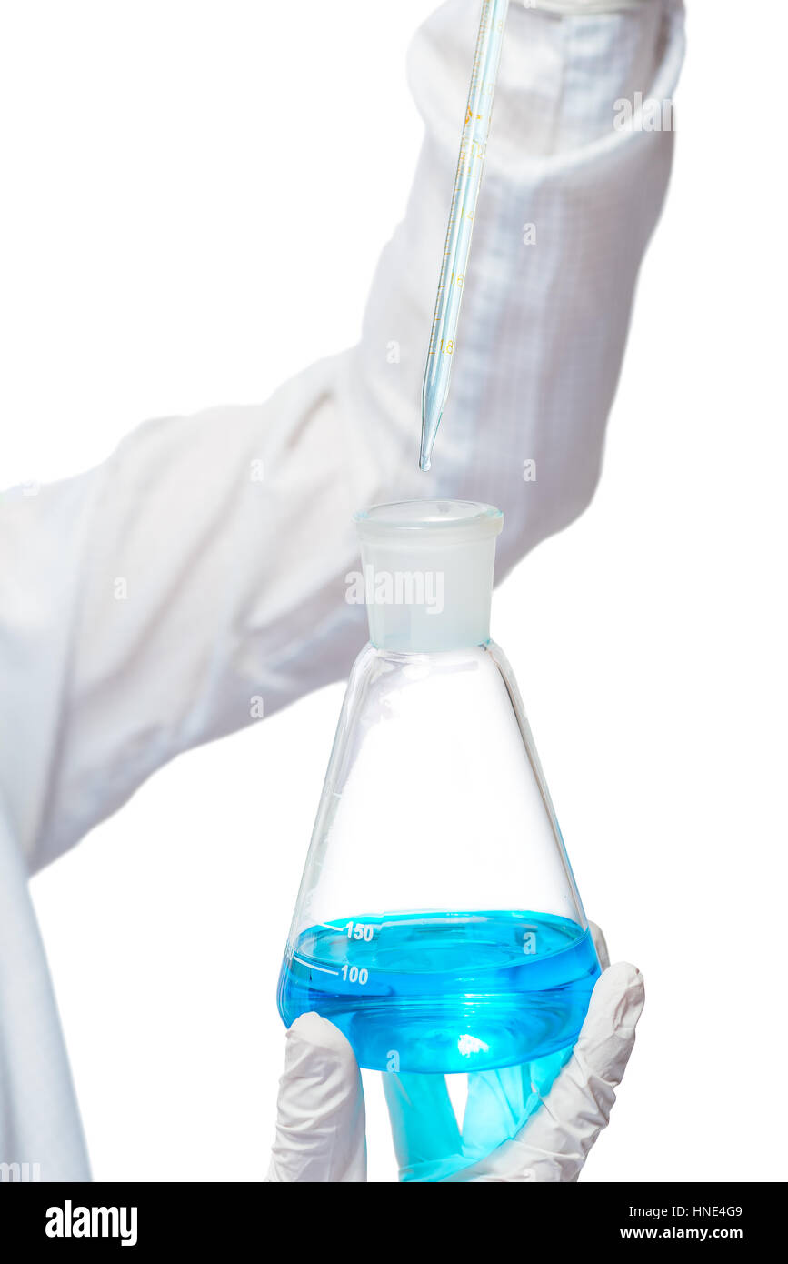 glass flask and pipette in the hands of an experienced chemist closeup ...