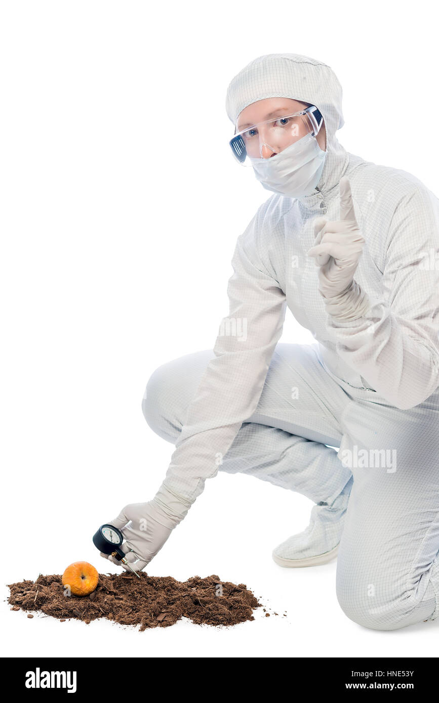 a researcher with the level meter of soil contamination on a white ...