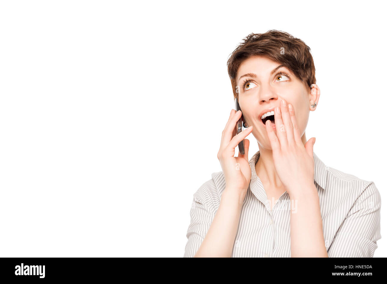 pleasantly shocked woman with mobile phone on a white background Stock ...