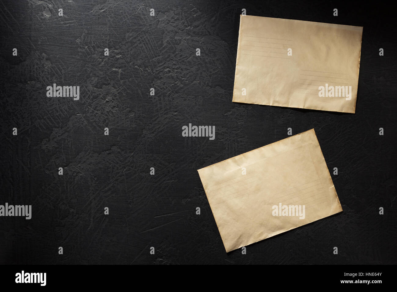 old postal envelope on black background Stock Photo - Alamy