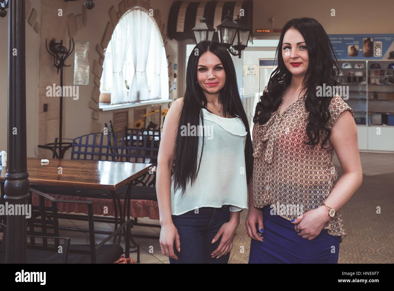 Two attractive models women posing for camera Stock Photo - Alamy