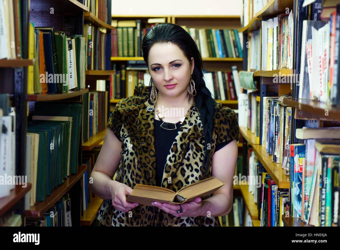 Beautiful female posing books standing hi-res stock photography and ...