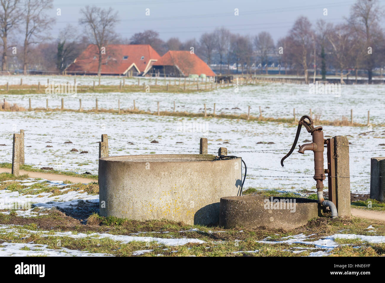 Dutch water pump and well in winter snow landscape Stock Photo - Alamy