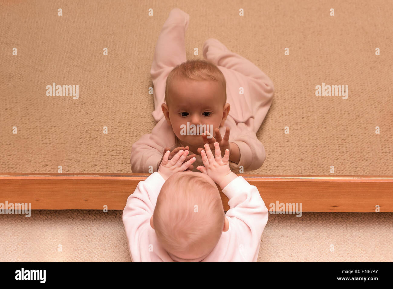 Baby little girl in a mirror, infant, toddler Stock Photo - Alamy