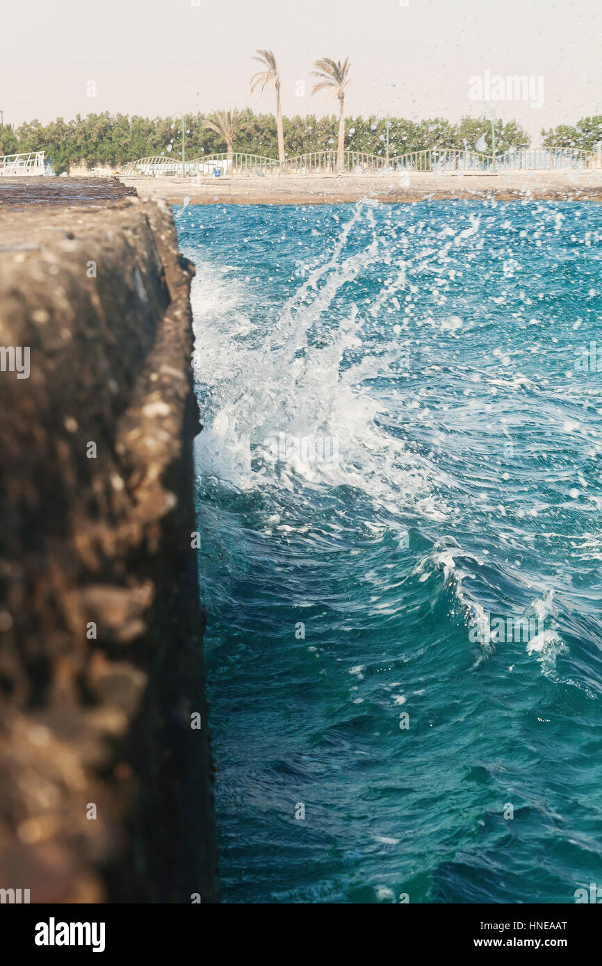 the waves strike the stone pier in blurring Stock Photo - Alamy