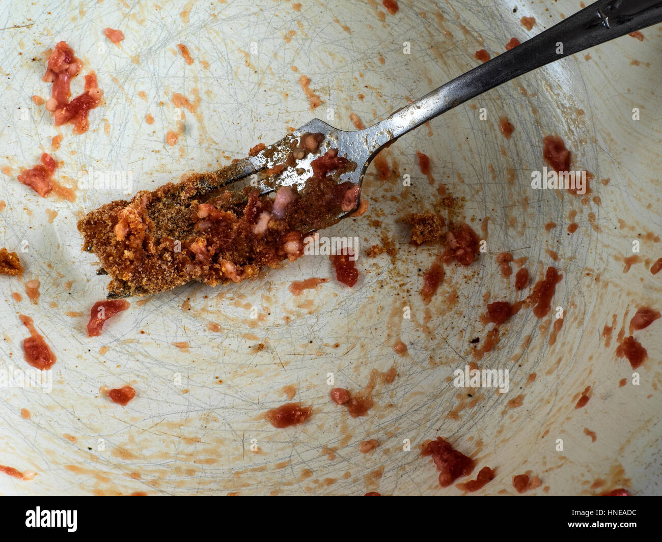 Cooking of cutlets. Empty bowl smeared with remnants of minced lamb ...