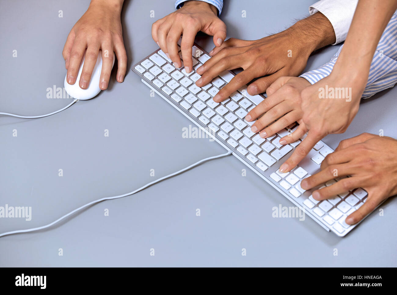 Human hands on computer keyboard with one hand using computer mouse ...